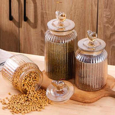 China Heart shaped lid, glass jar, sealed jar, colored storage jar, household flower tea storage, candy and snack jar for sale