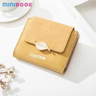 Китай Настроенный логотип PU Leaf Buckle Zipper Folding Student Coin Purse для простых и практичных продается