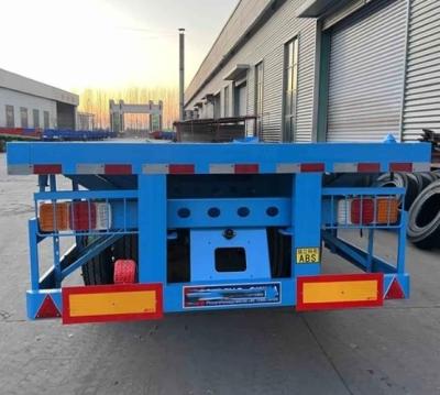 China 12.00R22.5 Tire 60 Tons 80 Tons Payload Flatbed Semi Trailer for Container Transport for sale