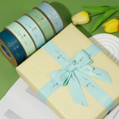 China Folha de ouro personalizada estampada fita satinada de poliéter para embalagem de presentes à venda