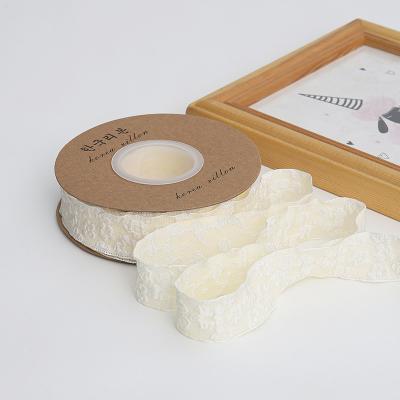 China Embossed Floral Lace Trim 25mm Polyester Champagne Lace Ribbon for sale