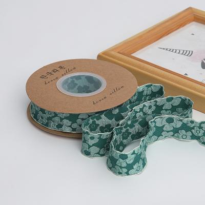 China Embossed Floral Lace Trim 25mm Polyester Champagne Lace Ribbon for sale