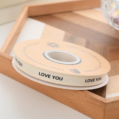 Cina 13mm Logo all'ingrosso Nastro di cotone Stile letterario Imballaggio di fiori Scatola regalo Decorazione Nastro Torta Bouquet in vendita