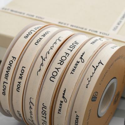 Cina 13mm Logo all'ingrosso Nastro di cotone Stile letterario Imballaggio di fiori Scatola regalo Decorazione Nastro Torta Bouquet in vendita
