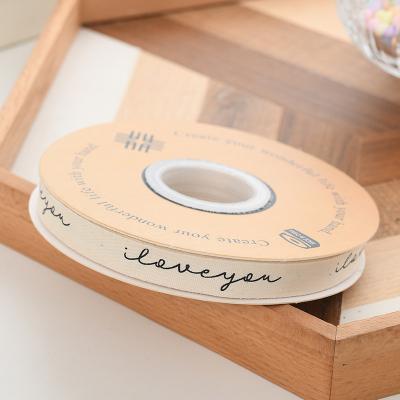 Cina 13mm Logo all'ingrosso Nastro di cotone Stile letterario Imballaggio di fiori Scatola regalo Decorazione Nastro Torta Bouquet in vendita