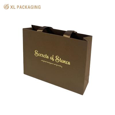 China Handmade Paper Packaging Bags Biodegradable Cosmetic Shopping Bag With Handle for sale