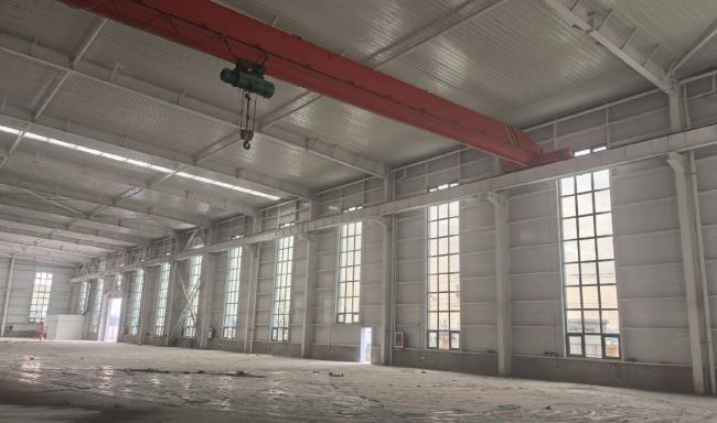 Steel structure manufacturing facility showing quality control processes