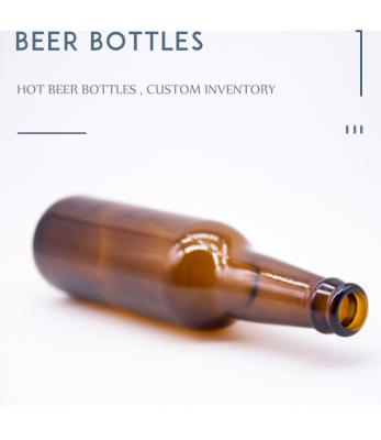 Cina Bottiglie vuote di lusso in vetro trasparente ambrato o marrone da 330 ml per bevande birra in vendita