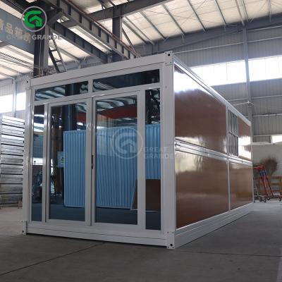 China Windproof And Warm 20ft Fold Out Container Homes Wood Grain Glass Manufacturer Te koop