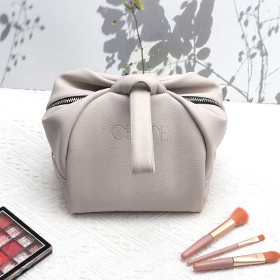 China Leather Handle Cosmetic Bag Emboss Custom Logo Portable Waterproof Leather Zipper Makeup Pouch for sale