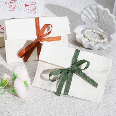 China Organic Canvas Cosmetic Perfume Storage Pouch With Bow Personalized Canvas Envelope Gift Packaging Bag for sale