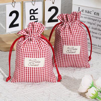 China Reusable Red Plaid Cotton Drawstring Packing Bag With Fabric Label Cotton Logo Cotton Drawstring Perfume Storage Bag for sale