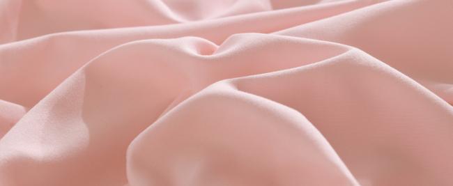 Soft pink comforter fabric close-up