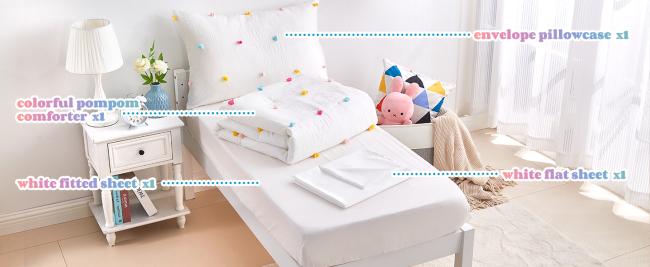All components of the 4-piece toddler bedding set laid out separately
