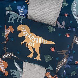 Close-up of dinosaur character design on fabric