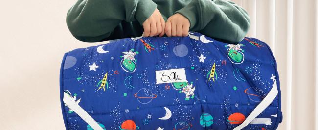 Rolled up toddler nap mat showing carrying handles