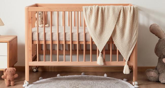 Set of two muslin bassinet sheets in rainbow and camel colors