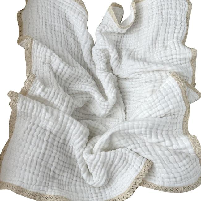 Gauze blanket in use as a baby swaddle