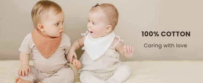 Baby wearing muslin bib showing absorbency