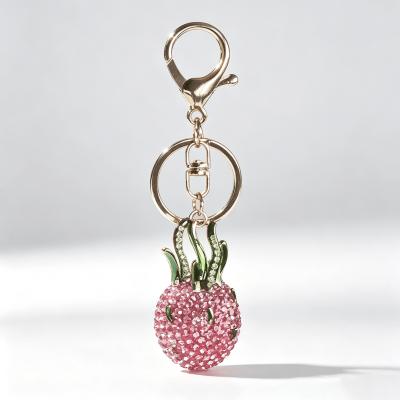 China Luxury Sparkling Rhinestone Pitaya Keychain Custom Crystal Dragon Fruit Bag Charm Pendant Key Ring Wholesale for sale