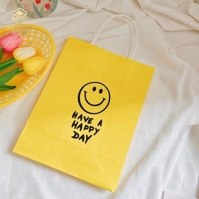 Cina l'altezza di 26cm ha ricoperto il regalo di carta giallo insacca riutilizzabile con il fronte di sorriso in vendita