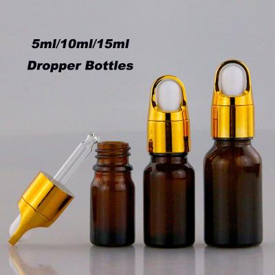 China Customized Accepted Essential Oil Small Round Empty Shiny Silver Gold Dropper Oil Bottle with Unique Flower Basket Rubber for sale