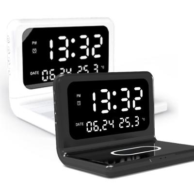 China Custom Mini Wireless Rechargeable Calendar Digital Clock Multifunctional Miniature Alarm Clock Mobile Phone Charging for sale