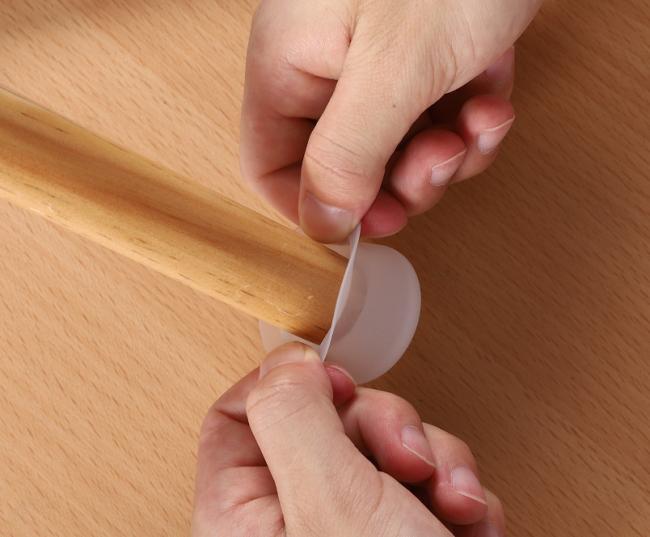 Silicone foot cover in use on chair leg