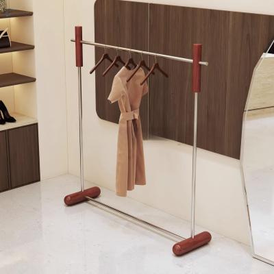 China Stainless Steel Walnut Display Prop Women's Middle Island Rack Floor Hanger Clothing Shelf for sale