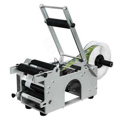 China Small Desktop Manual Round Bottle Labeling Machine Semi-Auto Adhesive Labeler for Glass Plastic Bottles for sale