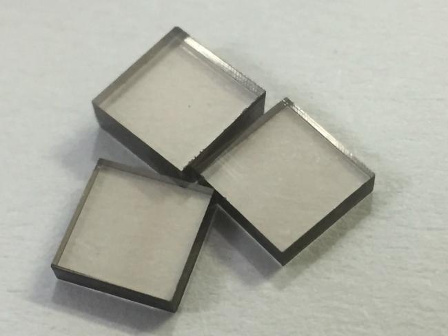 Monocrystaline CVD lab grown diamond sample showing brownish color and rectangular shape