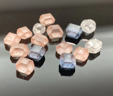 Multiple blue rough diamonds showing size variation