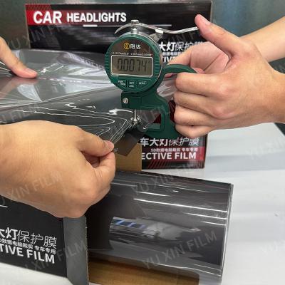 Cina Film per fari TPU a fumo nero per auto 0.3x15M Film di protezione UV anti-UV per fari in vendita