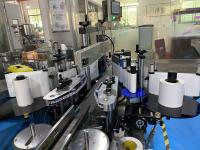 China Rotary Double Sides Labeling Machine 36 Labels Per Min for Flat Glass Lotion Bottles for sale