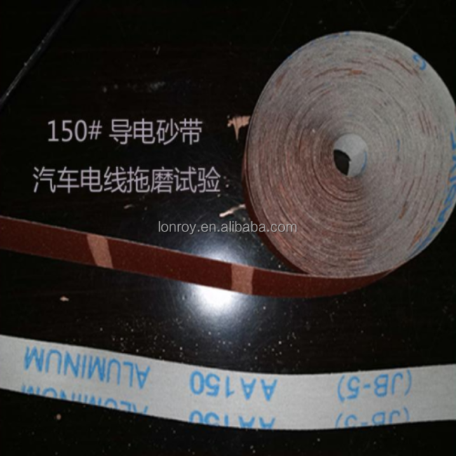 Close-up of abrasive belt mechanism on testing machine