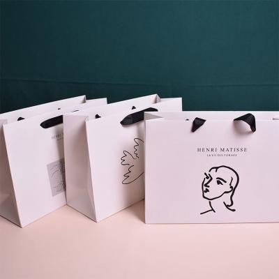 Cina Borsa da asporto con design personalizzato e maniglia a nastro nero in colore bianco avorio in vendita
