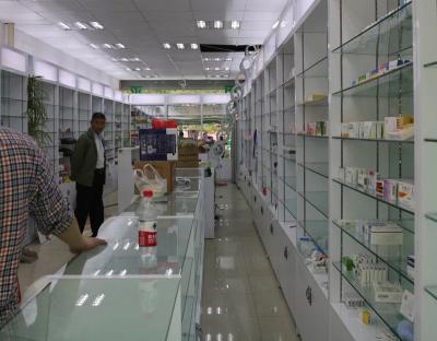China Customized Pharmacy Storage Cabinets Medicine Display Racks Glass Layer for sale