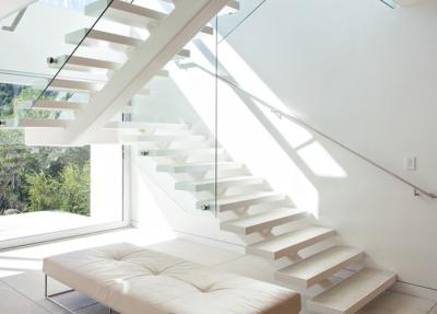 China 304s.s indoor curved wooden stairs with tempered glass balustrade for sale