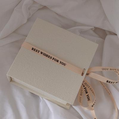 China Ribbon Tied Textured Foldable Gift Boxes Closure Makeup Jewelry Presentation Box for sale