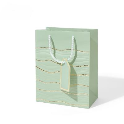 China Pastel Gold Wave Design Gift Bags Premium Embossed Paper Bags with Rope Handles Ideal for Weddings Birthdays Shopping Elegant & Sturdy for sale