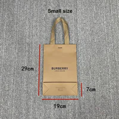 Cina 200pcs al nastro dei sacchi di carta dell'abbigliamento di timbratura di oro 500pcs tratta i sacchetti della spesa di Kraft in vendita