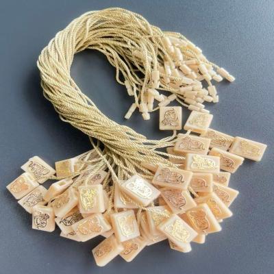China Unique And Eye-catching Plastic Tag Fastener Embossed Technic Ideal Clothing Tagging Durable Secure Attachment Solutions for sale