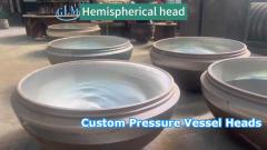 stacked hemispherical pressure‑vessel heads waiting for final inspection