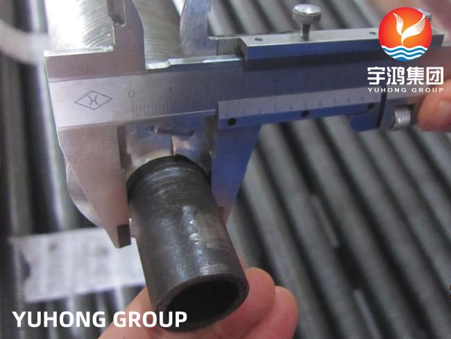 Wound fin tube product sample showing aluminum fins wound around steel base tube