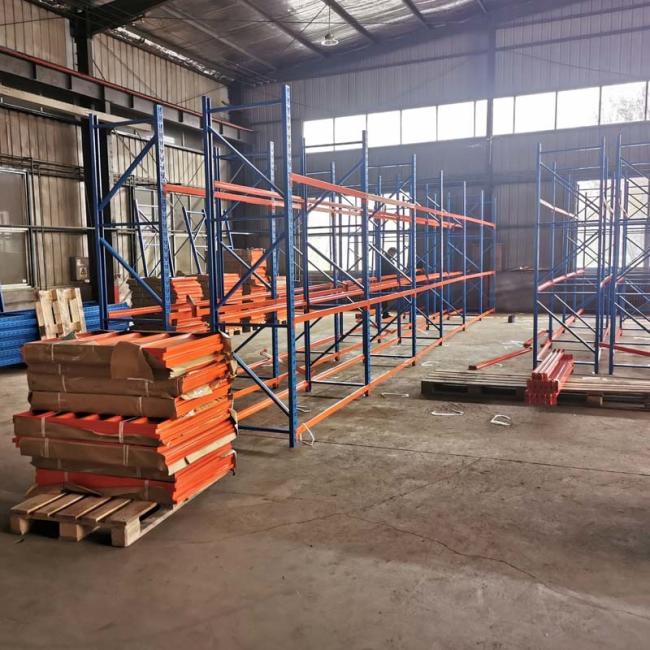 Industrial shelving unit with orange frame in warehouse
