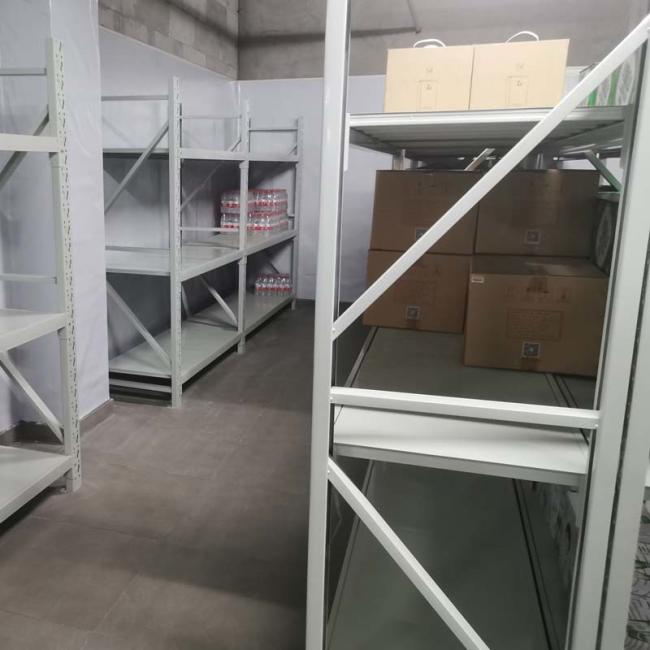 Metal rivet rack shelving unit in warehouse setting