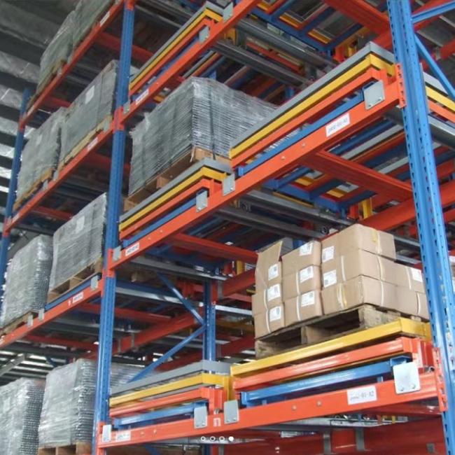 Forklift operator loading pallets into push back shelving