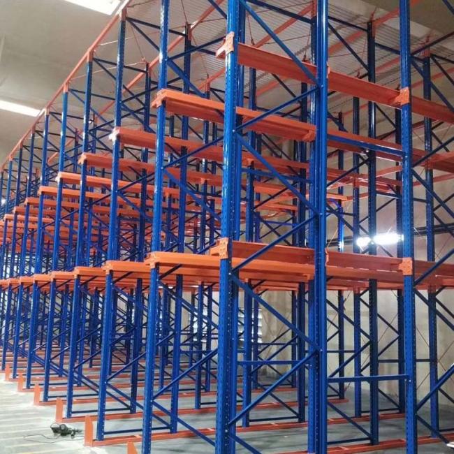 Heavy duty drive-in pallet racking system in warehouse setting