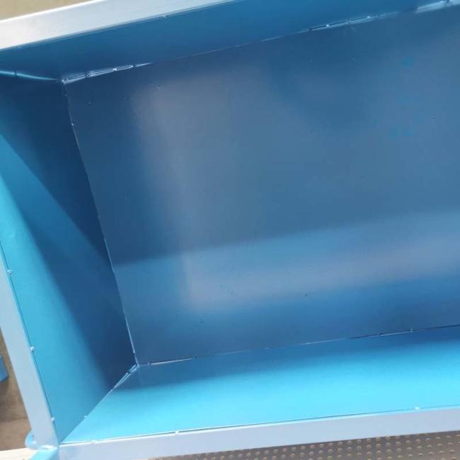 Grid metal pallet bin loaded with industrial parts