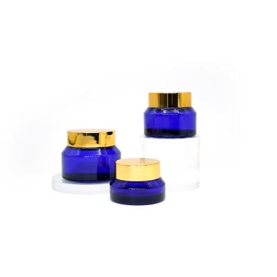 Cina Barattolo di vetro dei cosmetici blu di Hanya Glass Lotion Bottles 30g 50g in vendita